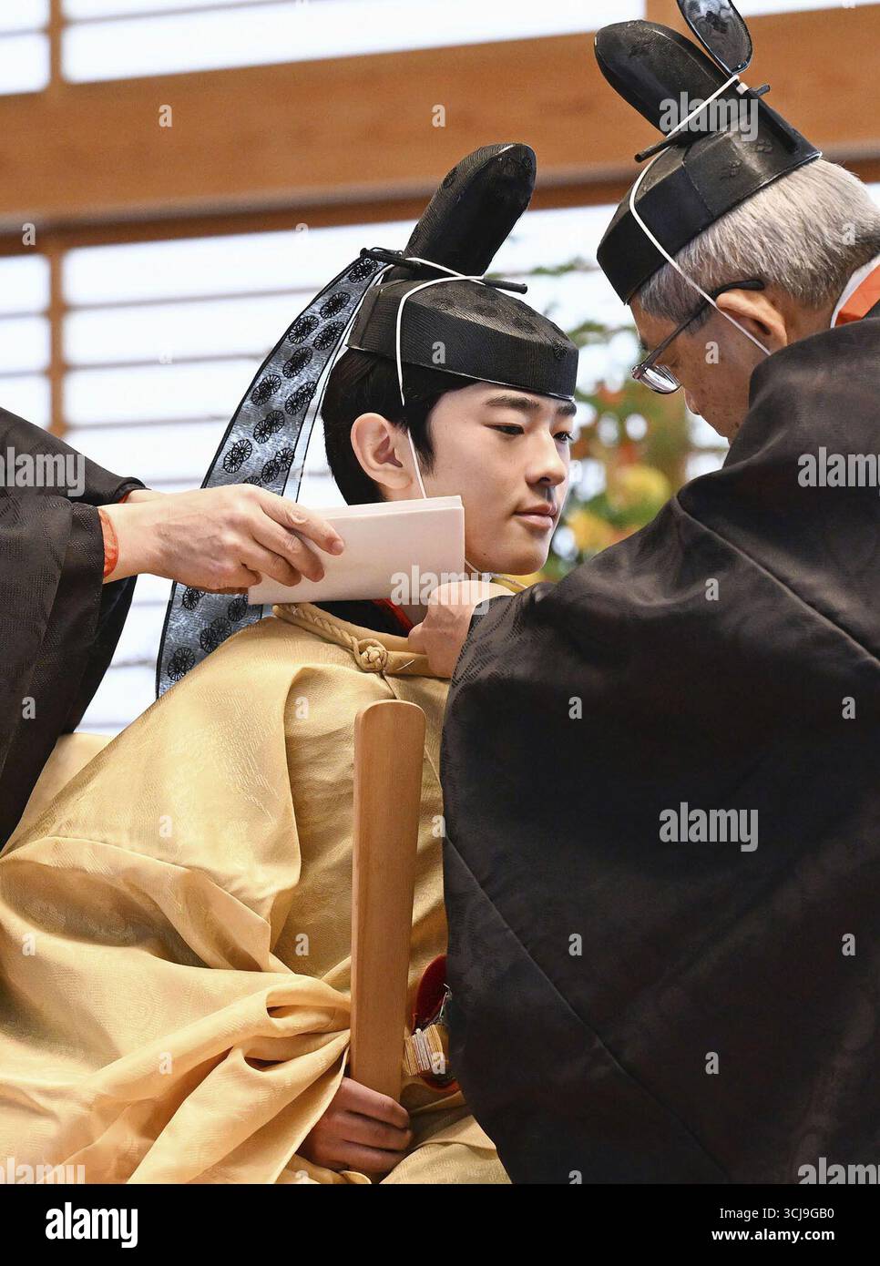 Japanese Prince Hisahito, in ceremonial attire, has a crown bestowed by ...