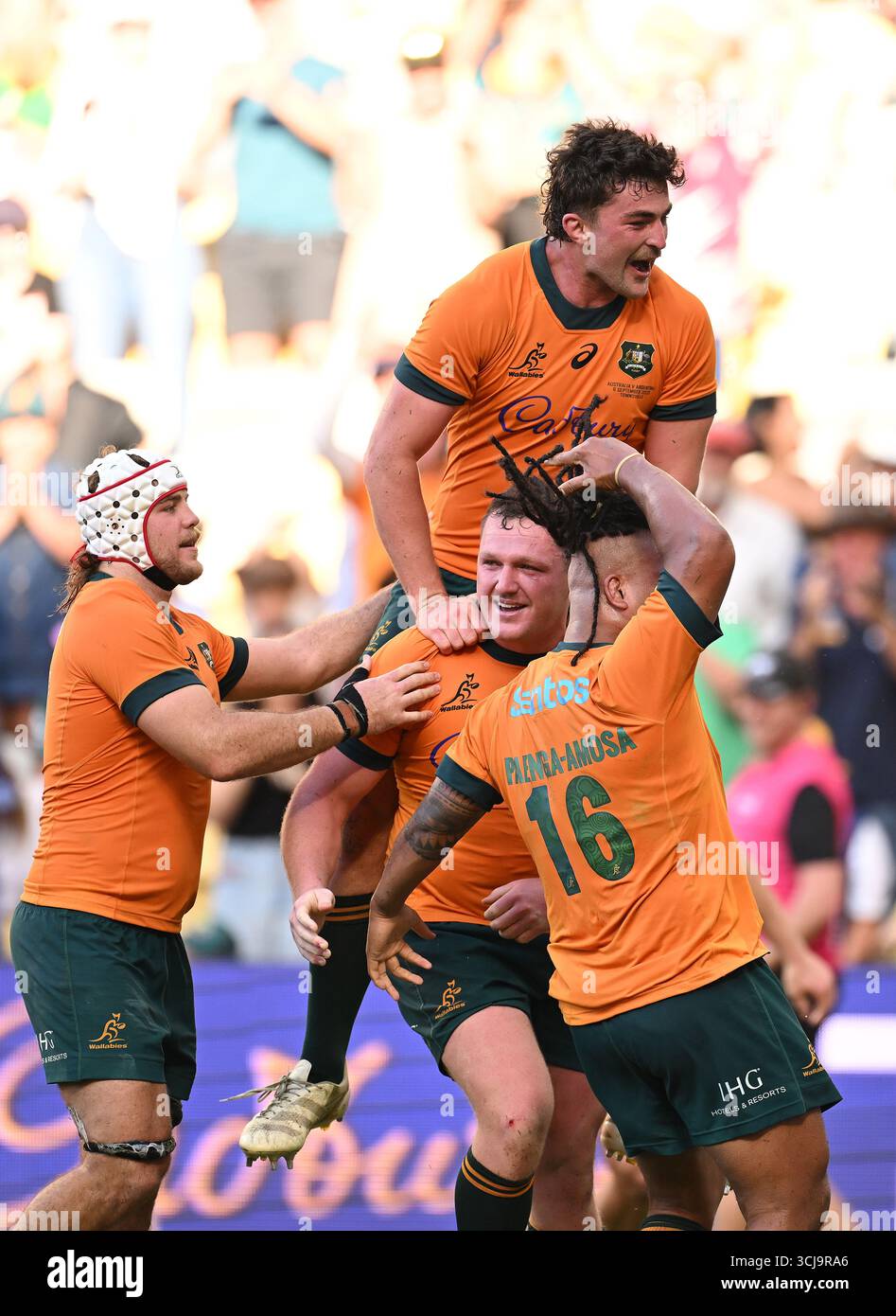 Angus Bell of the Wallabies (centre) celebrates after scoring the match ...