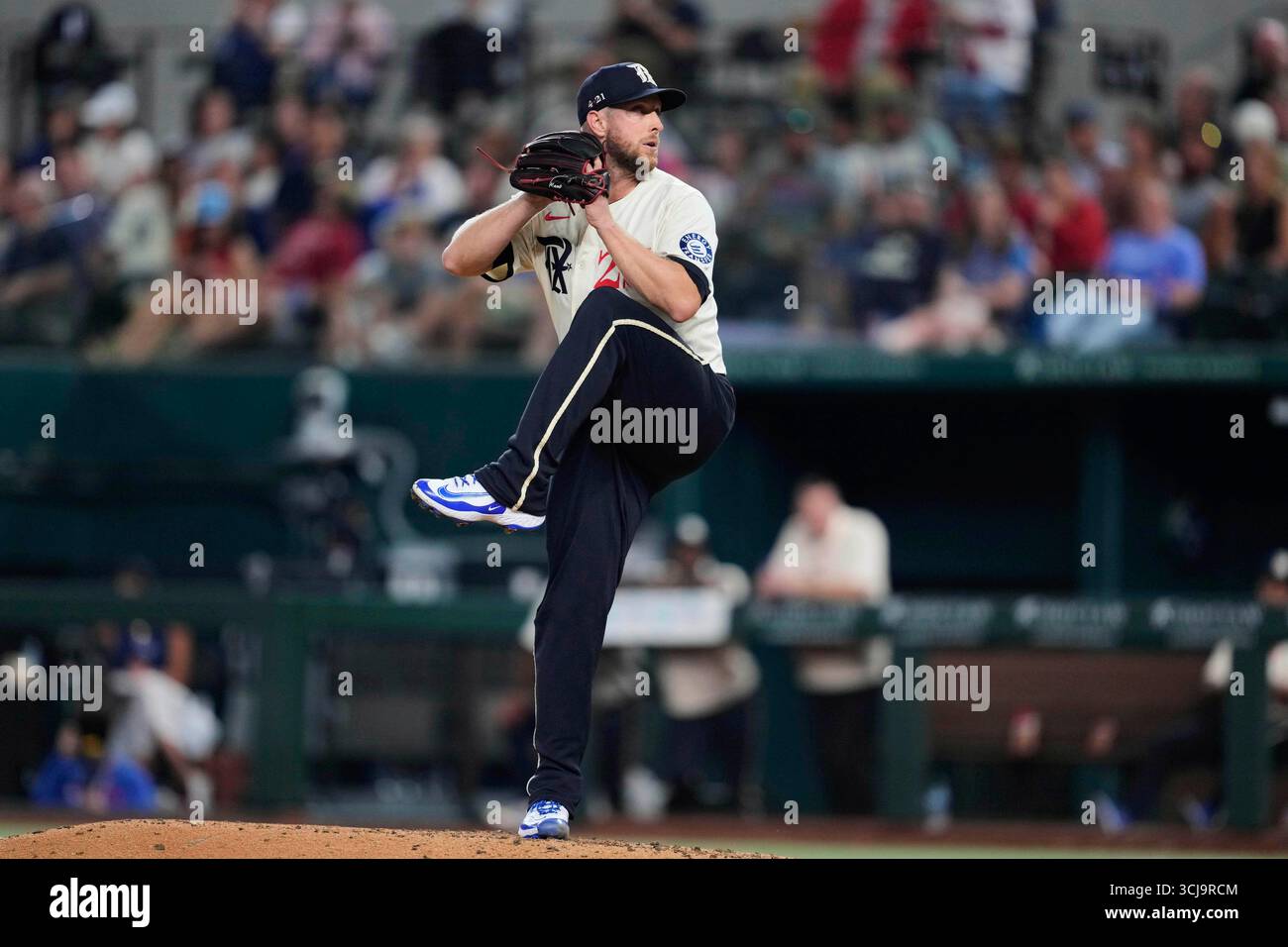 Texas Rangers starting pitcher Merrill Kelly winds up to deliver to the ...