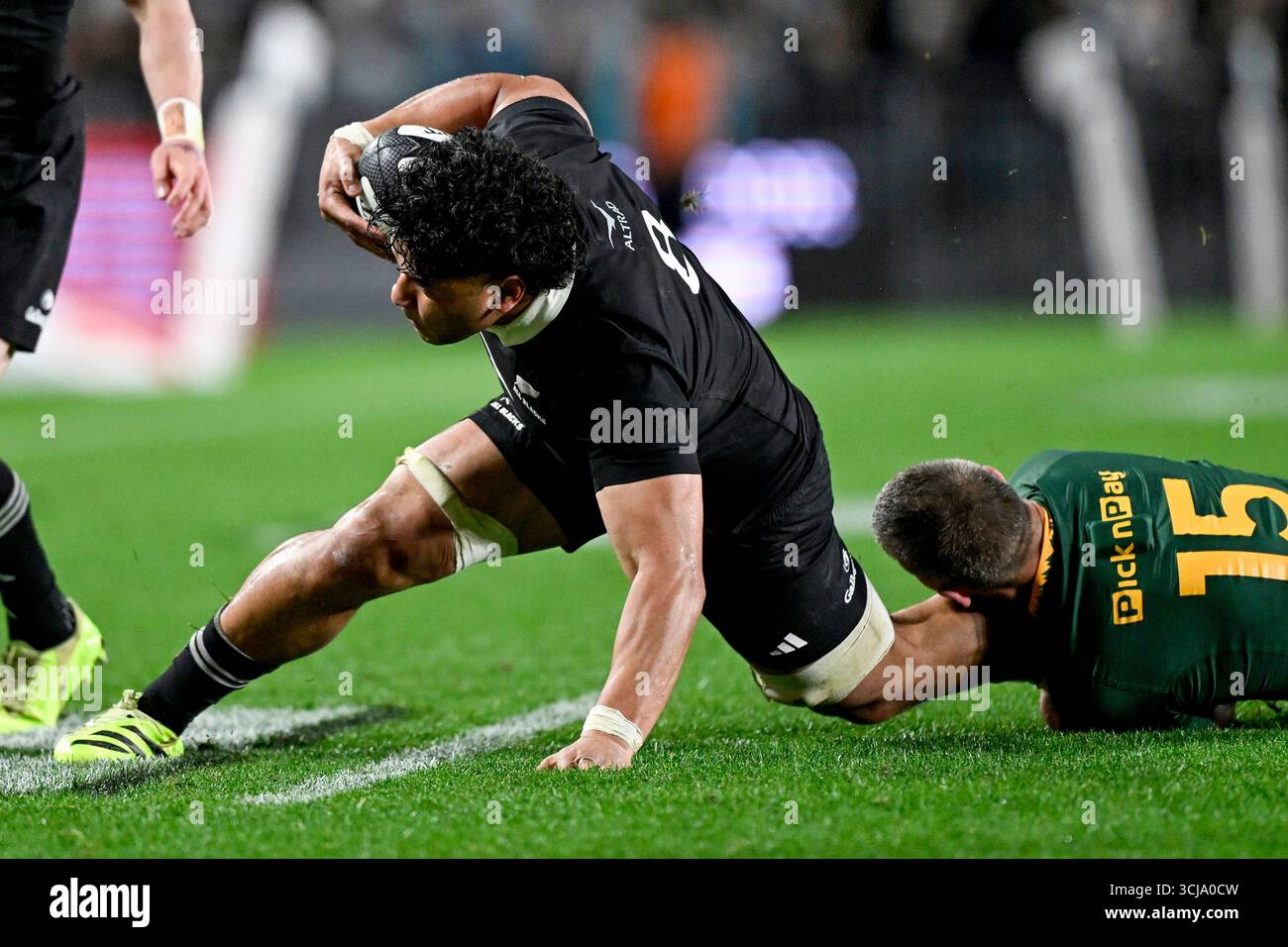 Wallace Sititi of New Zealand attempts to break the tackle of South ...