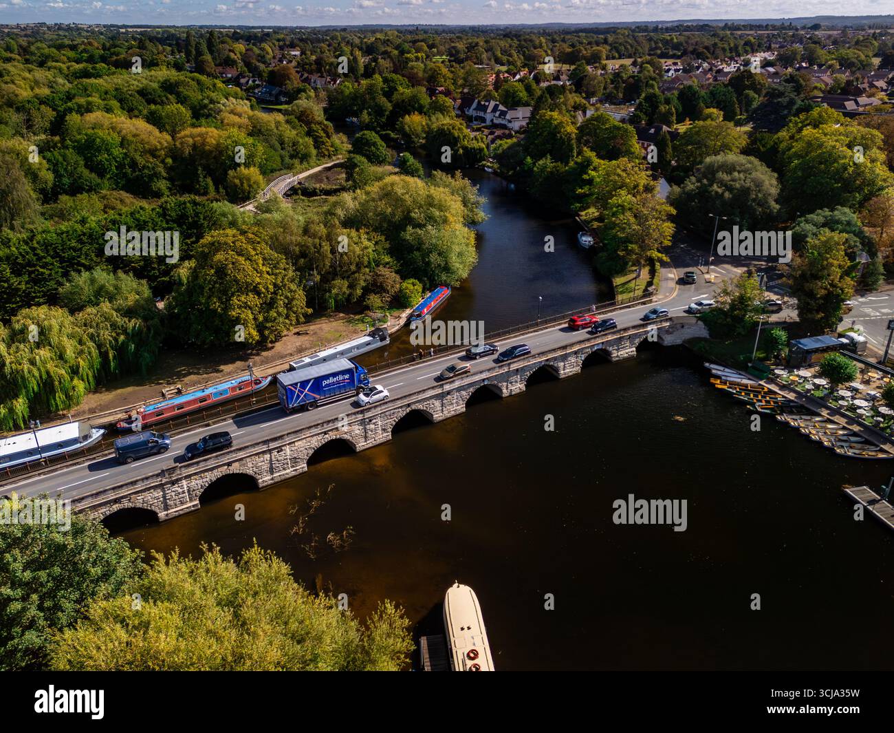 Aerial view of cars crossing bridge over river avon with boats moored ...