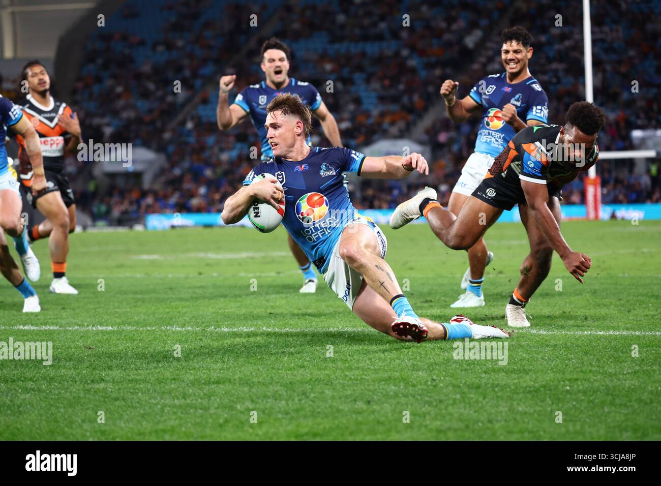 AJ Brimson of the Titans scores a try during the NRL Round 27 match ...