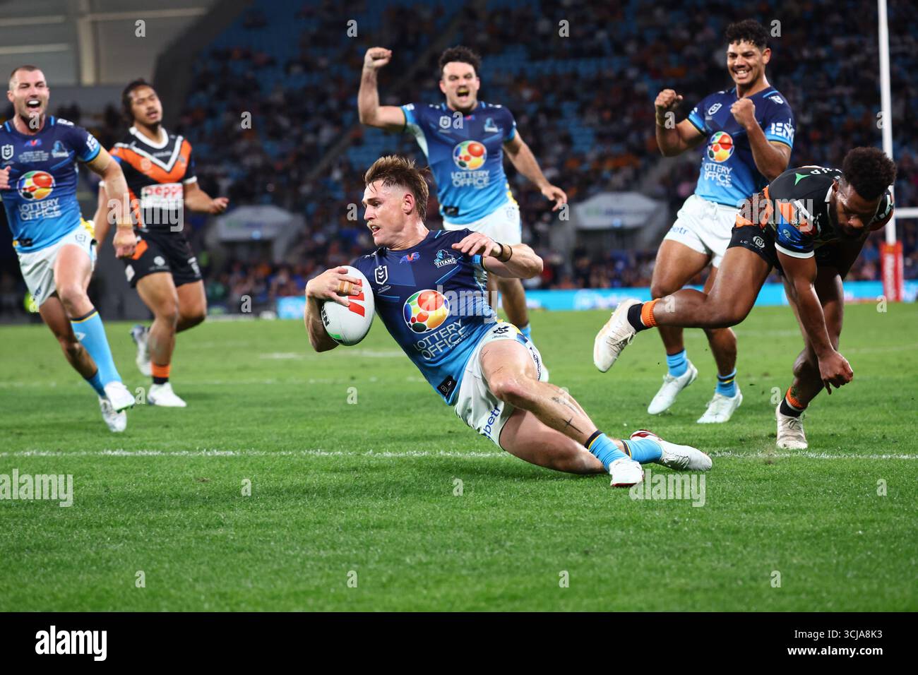 AJ Brimson of the Titans scores a try during the NRL Round 27 match ...