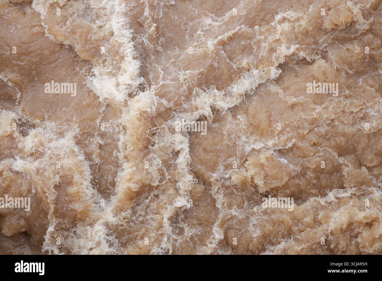 Water flow released from the dam gates. Brown turbulent current water ...