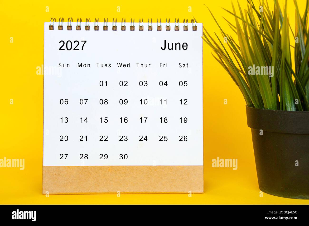 June 2027 desk calendar template with structured dates, yellow ...