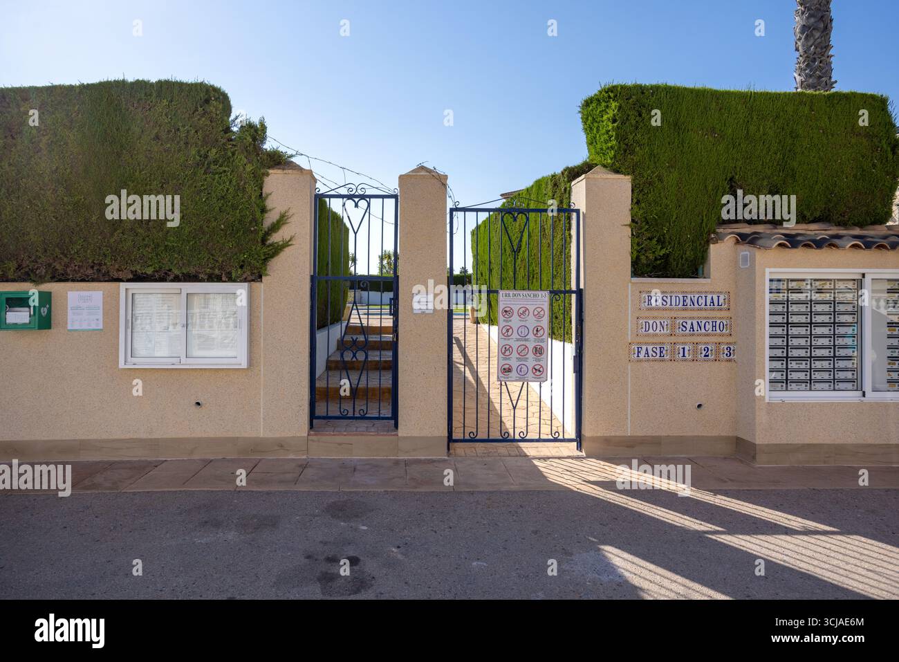 Double gated entrance to pool area with community signage and ...