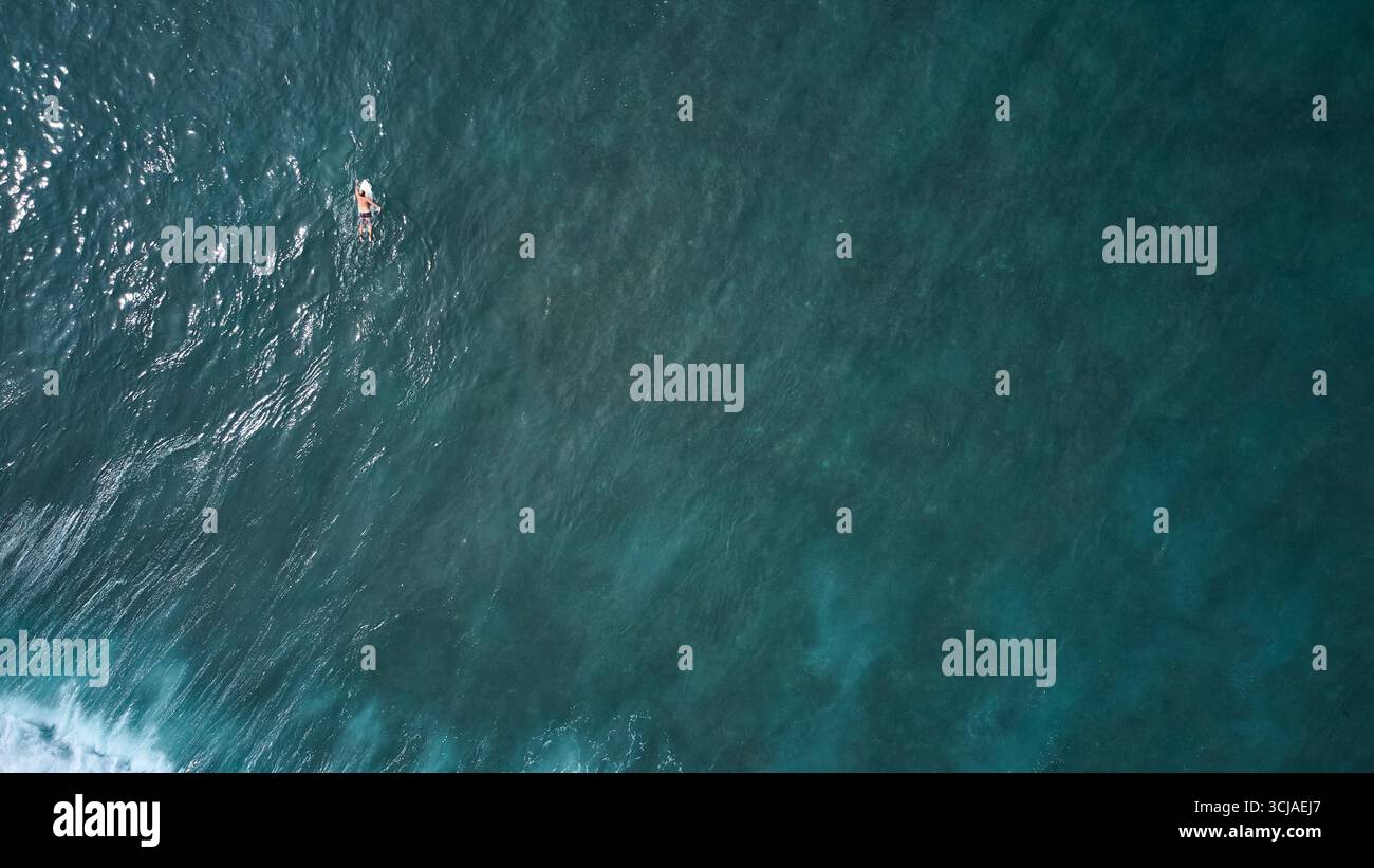 Aerial view of the ocean and surfer man Stock Photo - Alamy