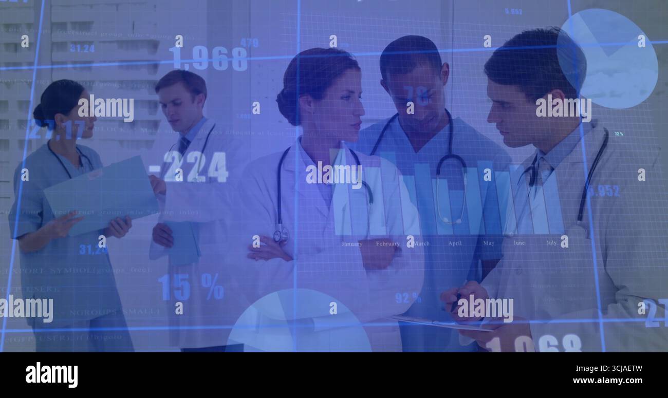 Medical team discussing clinical metrics in hospital corridor, with ...
