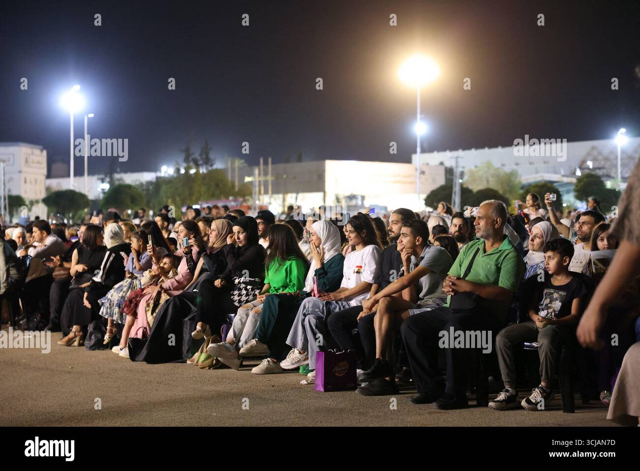 Audience members enjoy a musical performance during the Damascus ...
