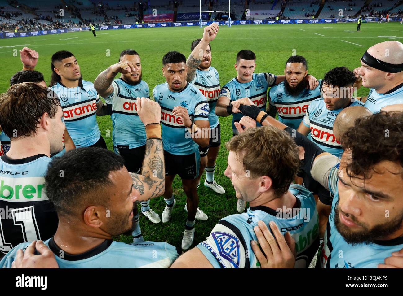 Sharks players huddle after victory during the NRL Round 27 match ...