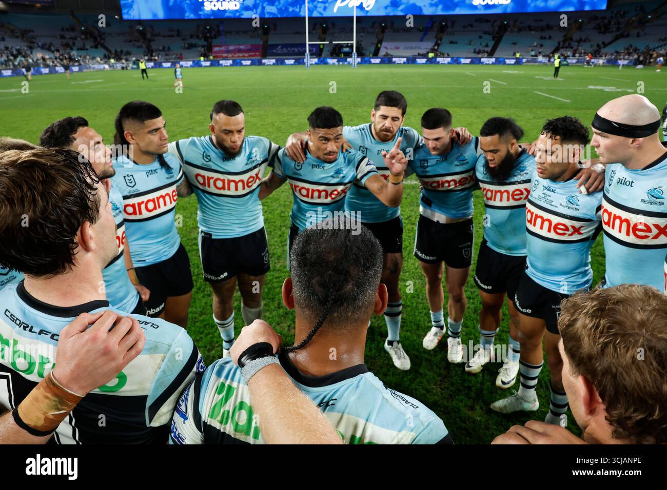 Sharks players huddle after victory during the NRL Round 27 match ...