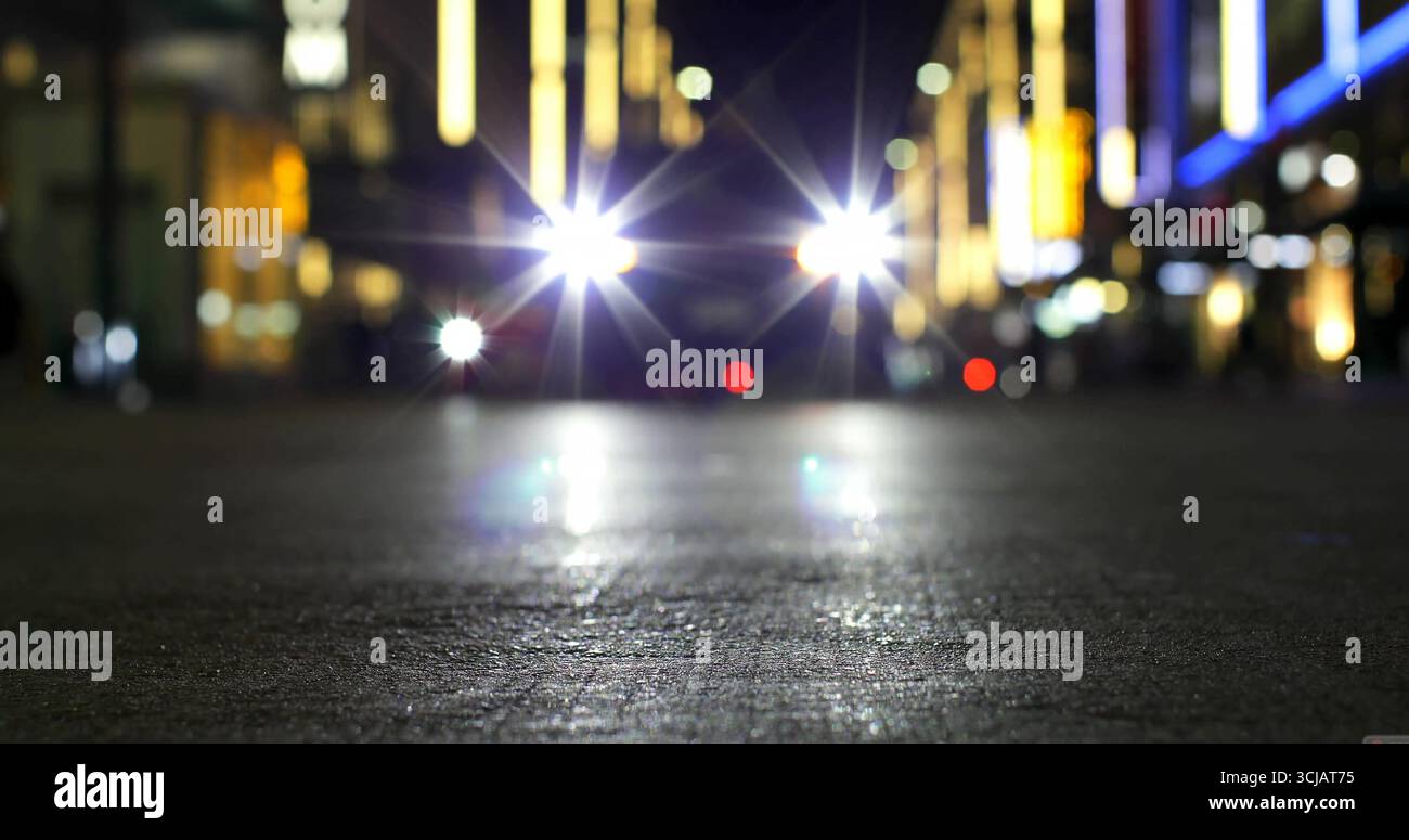 Glowing vehicle headlights creating starburst lens flares on night ...
