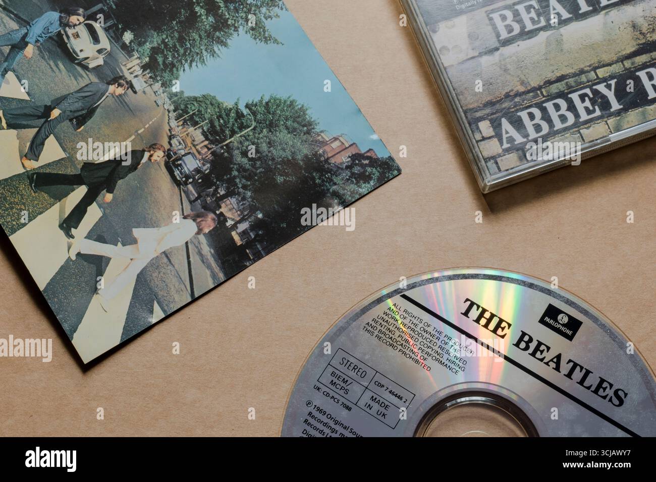 The Beatles 'Abbey Road' CD with album covers, isolated on light plain ...