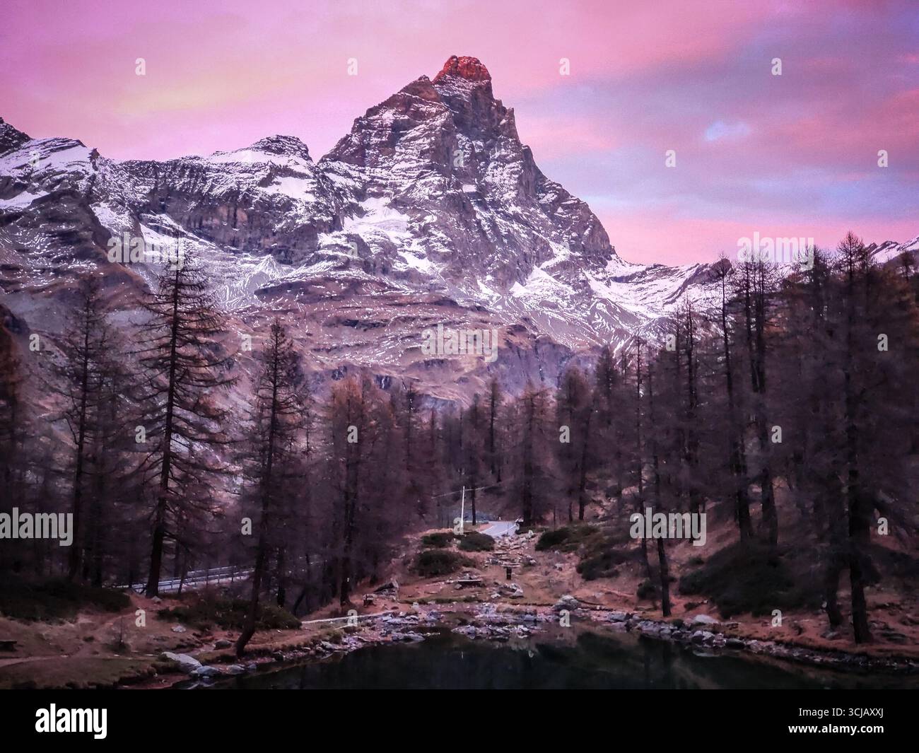 The iconic Matterhorn (Monte Cervino) glows with a brilliant alpenglow ...