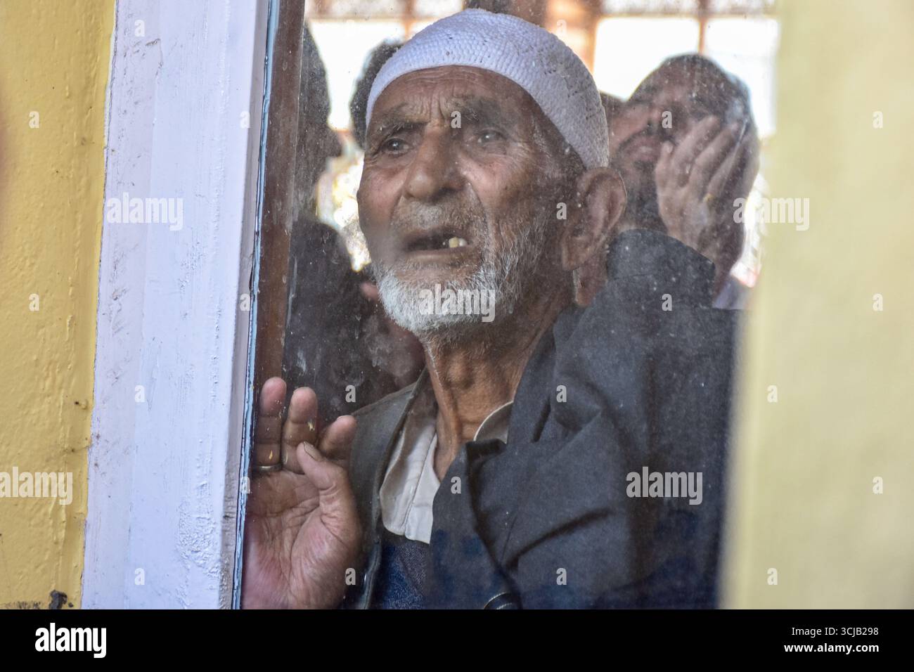A Kashmiri Muslim devotee prays as the head priest (not in view ...