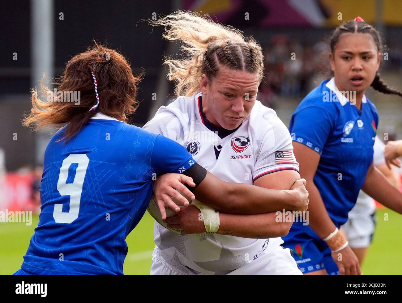 USA's Hope Rogers (centre) breaks free from the tackle of Samoa’s Ana ...