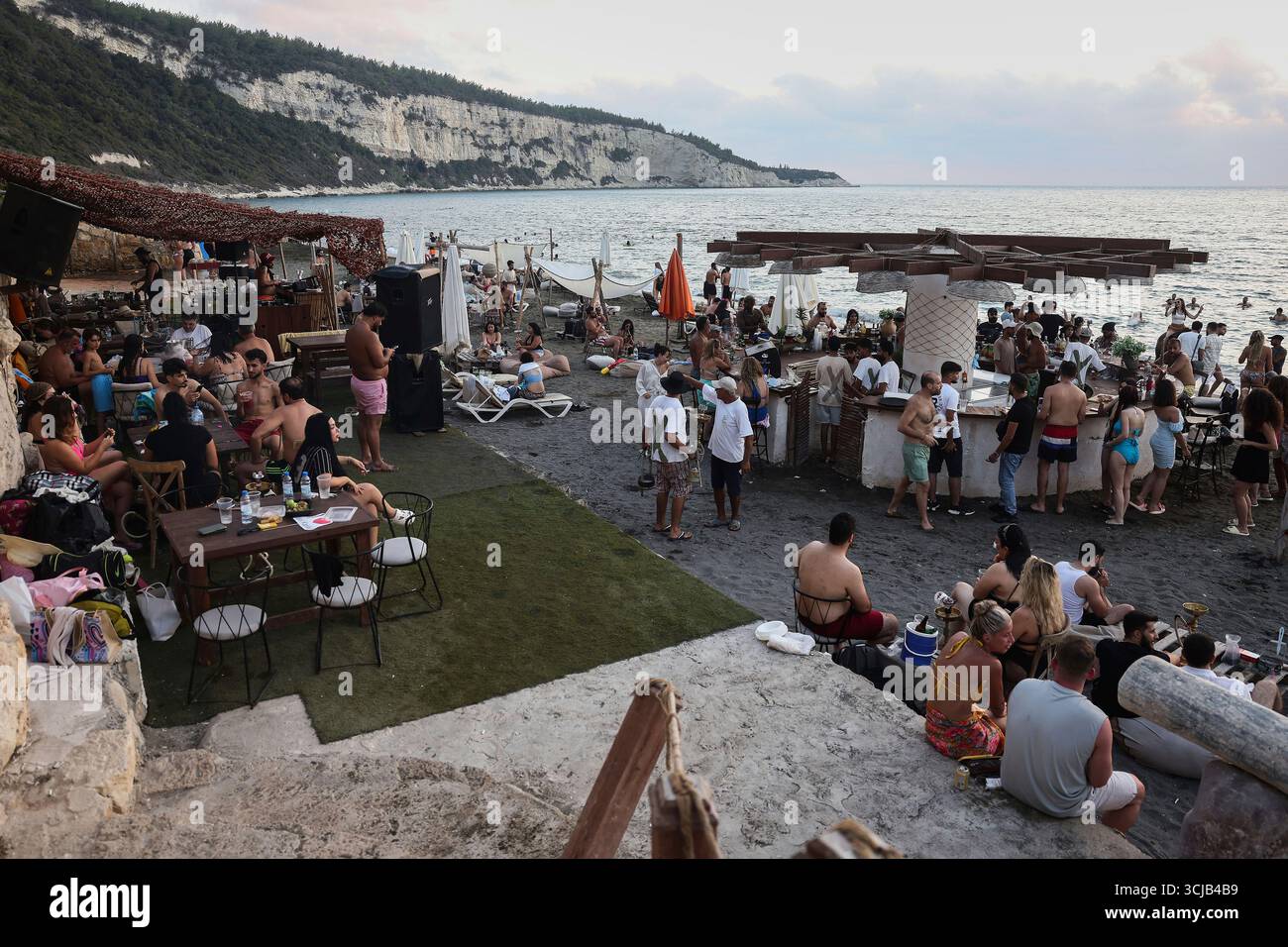 Syrian beachgoers enjoy their day at a beach resort in Wadi Qandil ...