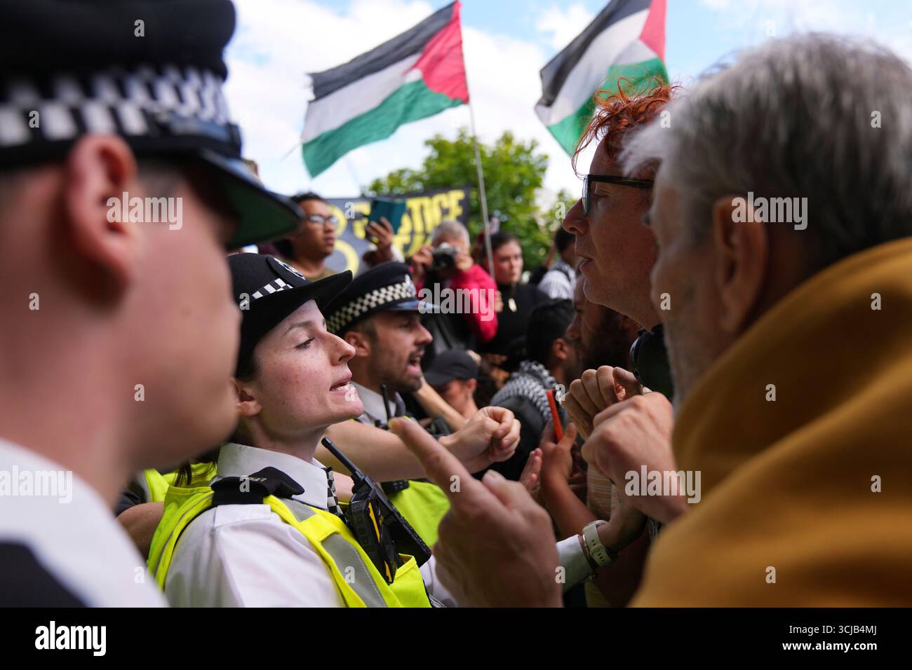 Protesters argue with police officers during a protest to support ...