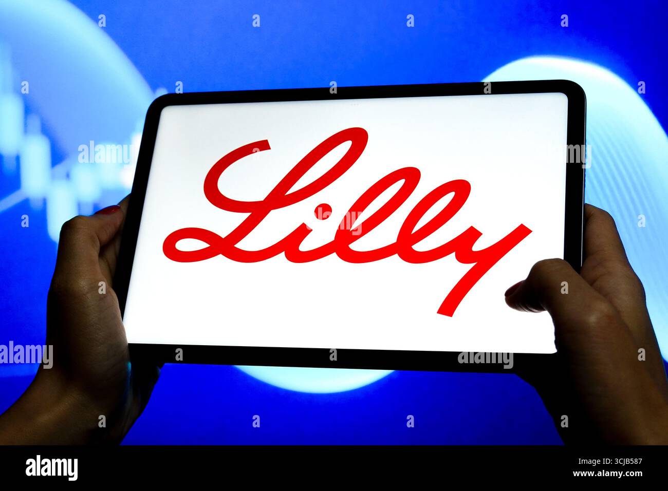 In this photo illustration, a Lilly logo is seen displayed on the ...