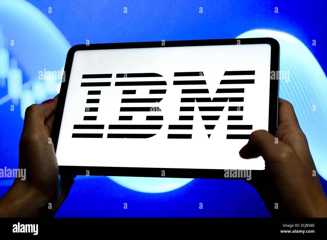In this photo illustration, an IBM logo is seen displayed on the screen ...