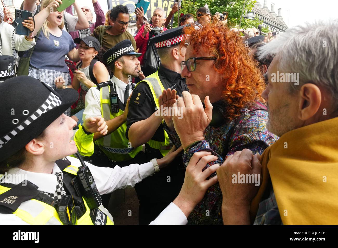 Police officers with demonstrators as people take part in a Lift the ...
