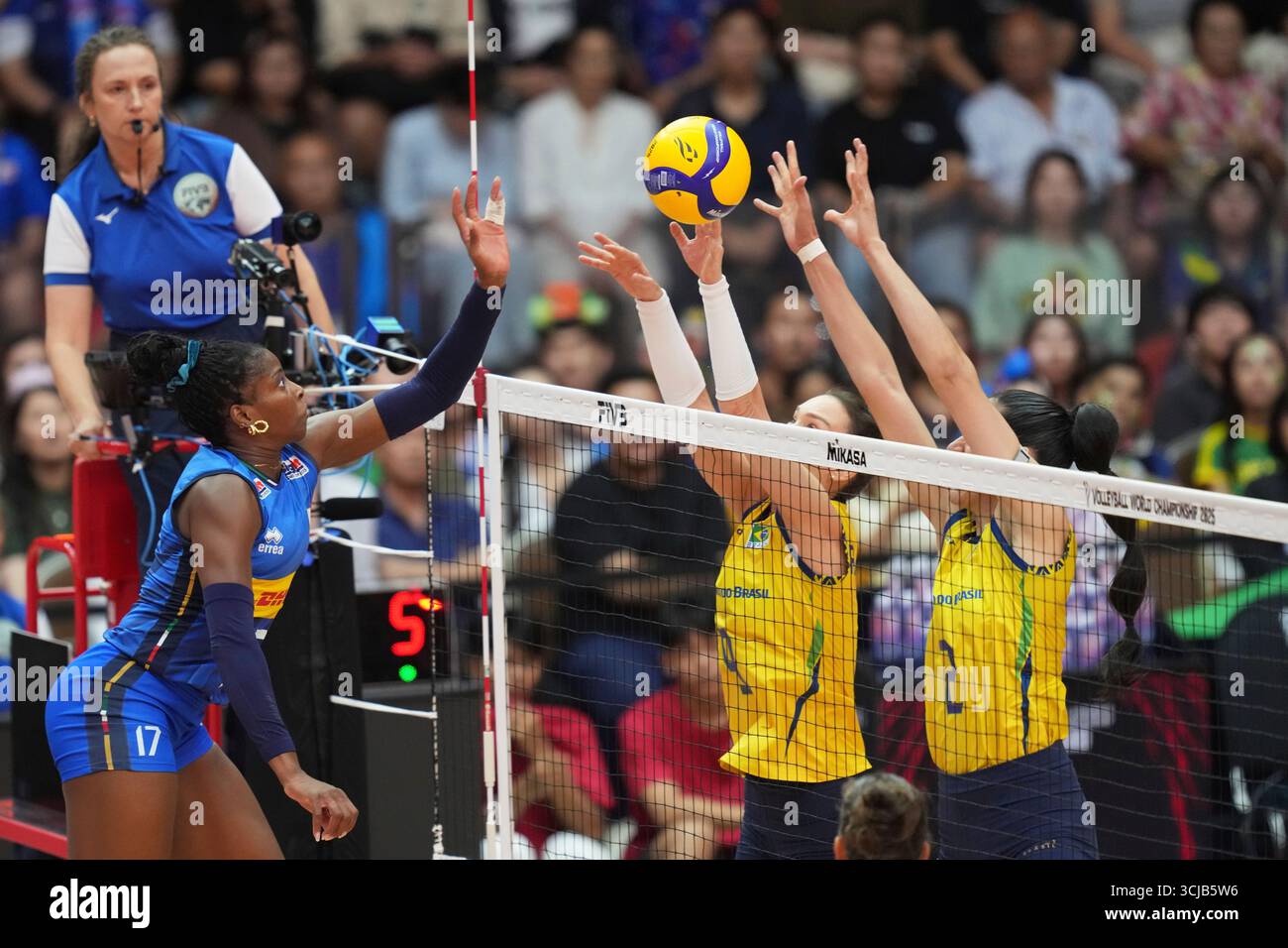 Italy's Myriam Fatime Sylla, left, spikes against Brazil's Diana Duarte ...
