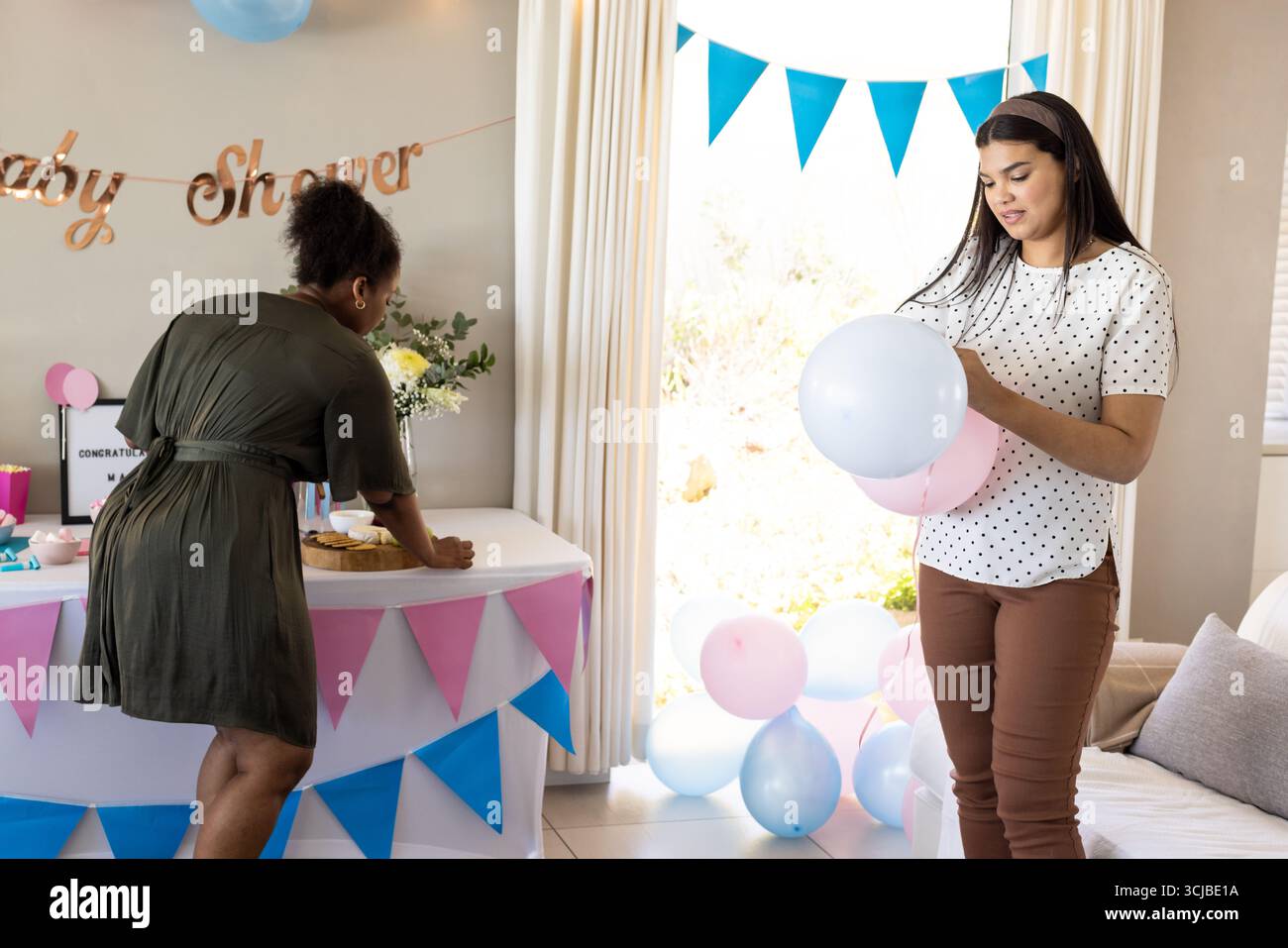 Women decorating baby shower hi-res stock photography and images - Alamy