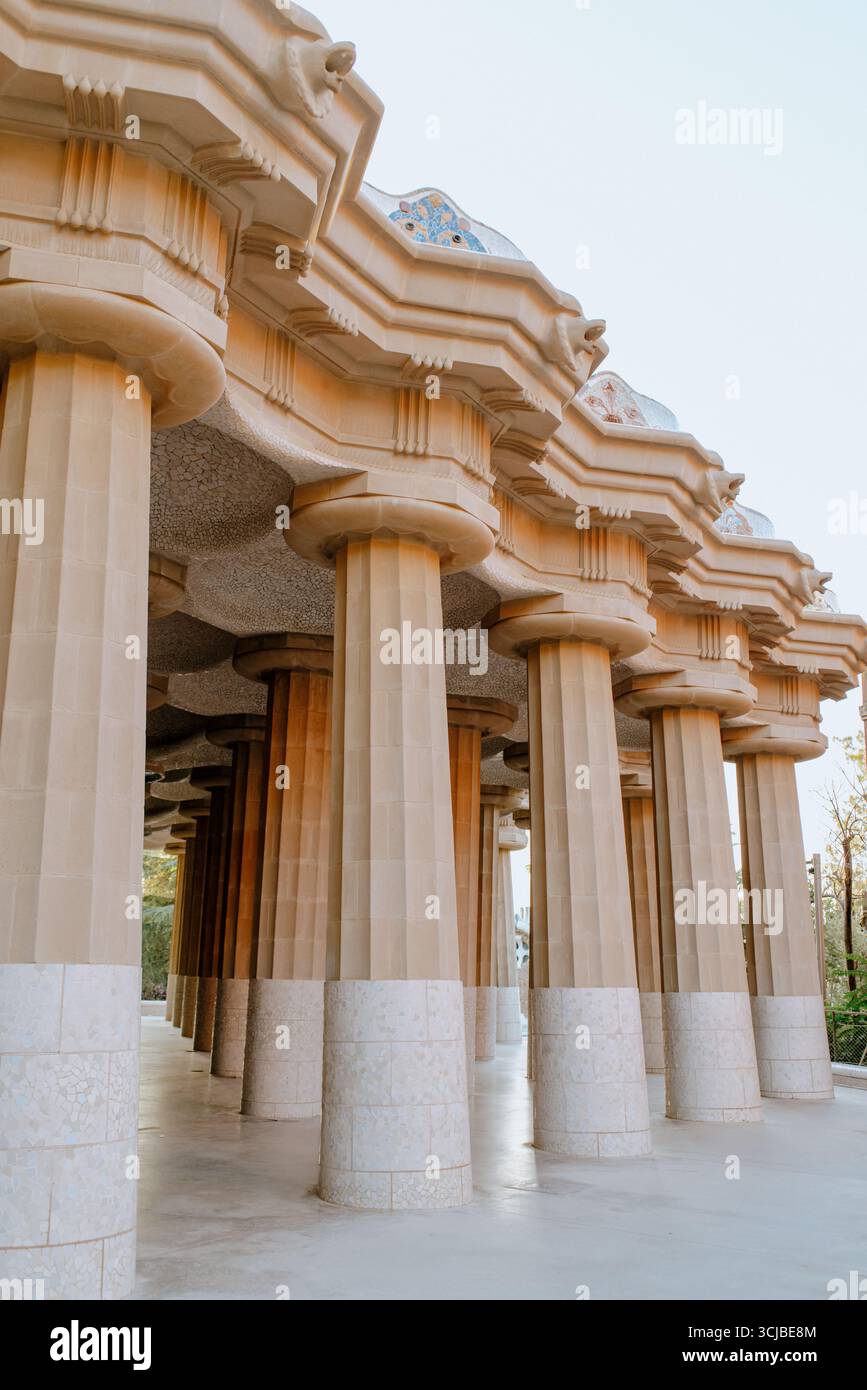 Low angle view of the iconic pillars of the main platform of Park Güell ...