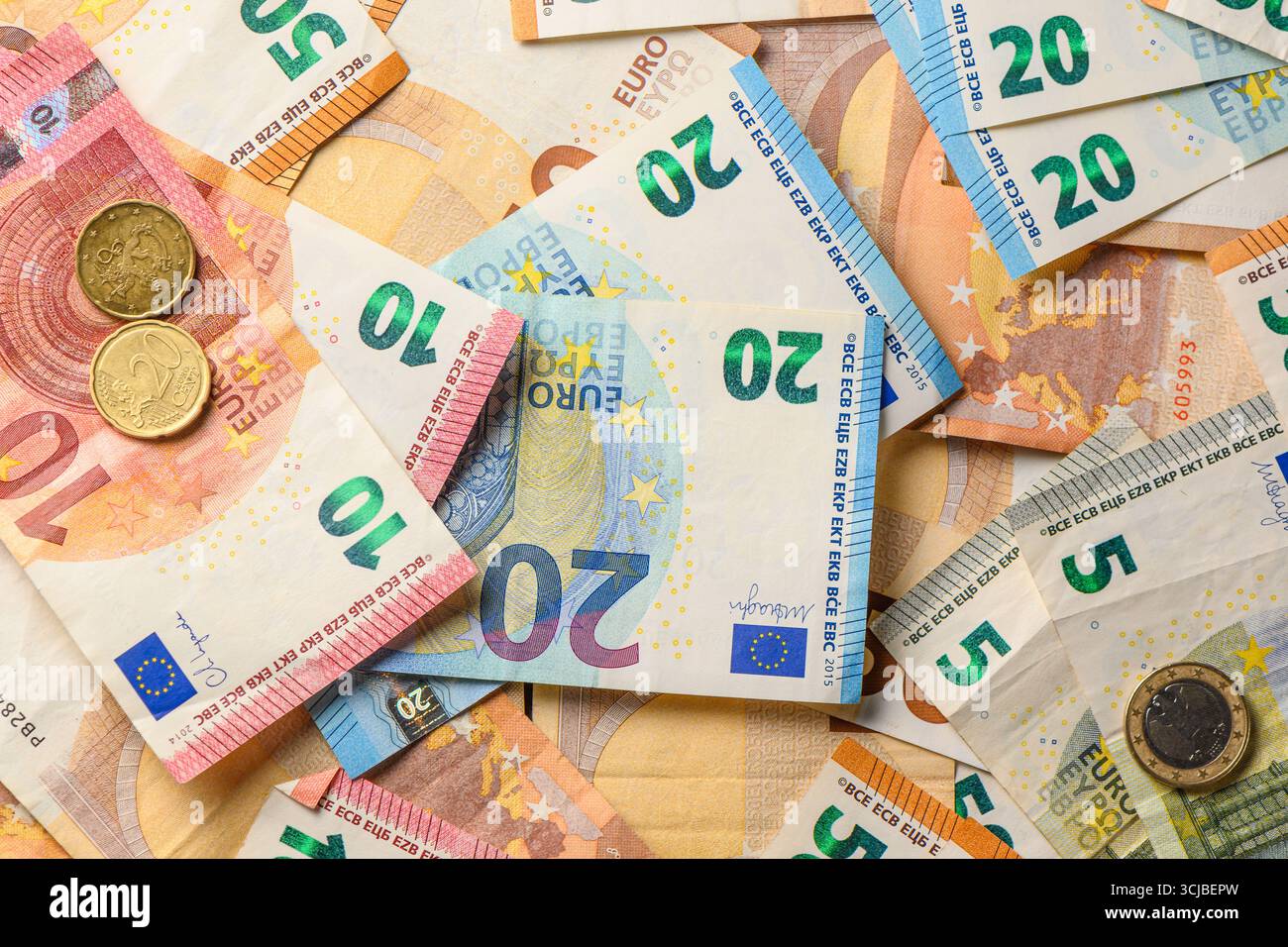 Close-up of mixed euro banknotes spread on table, representing European ...