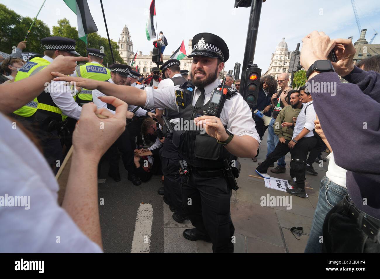 Police officers with demonstrators as people take part in a Lift the ...