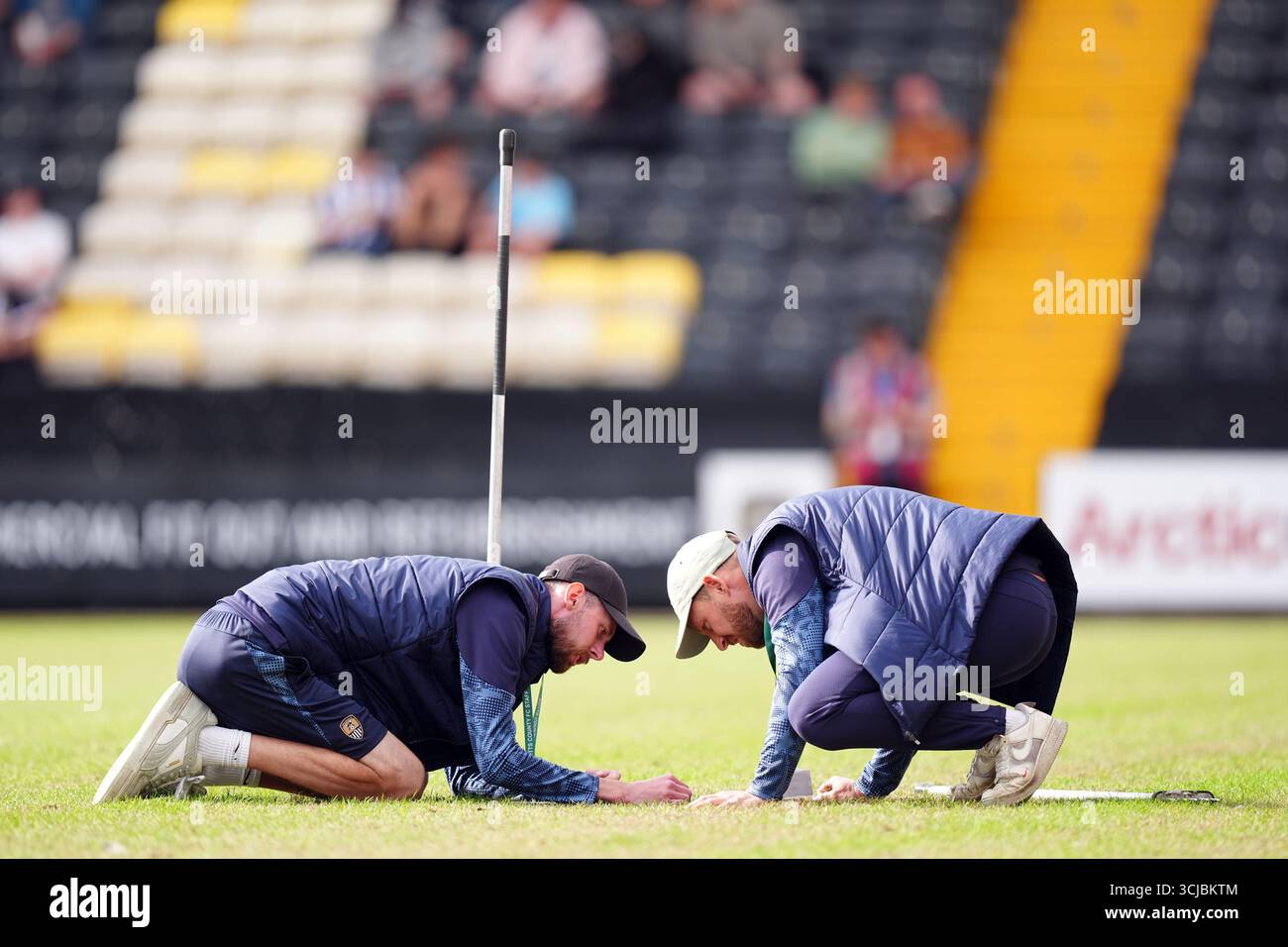 A general view of ground staff at Notts County working on the pitch ...