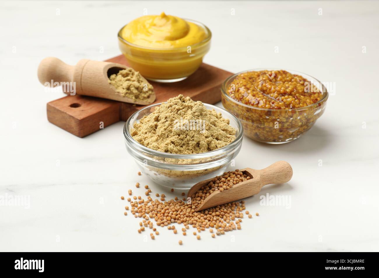 Different types of mustard on white marble table, closeup Stock Photo ...