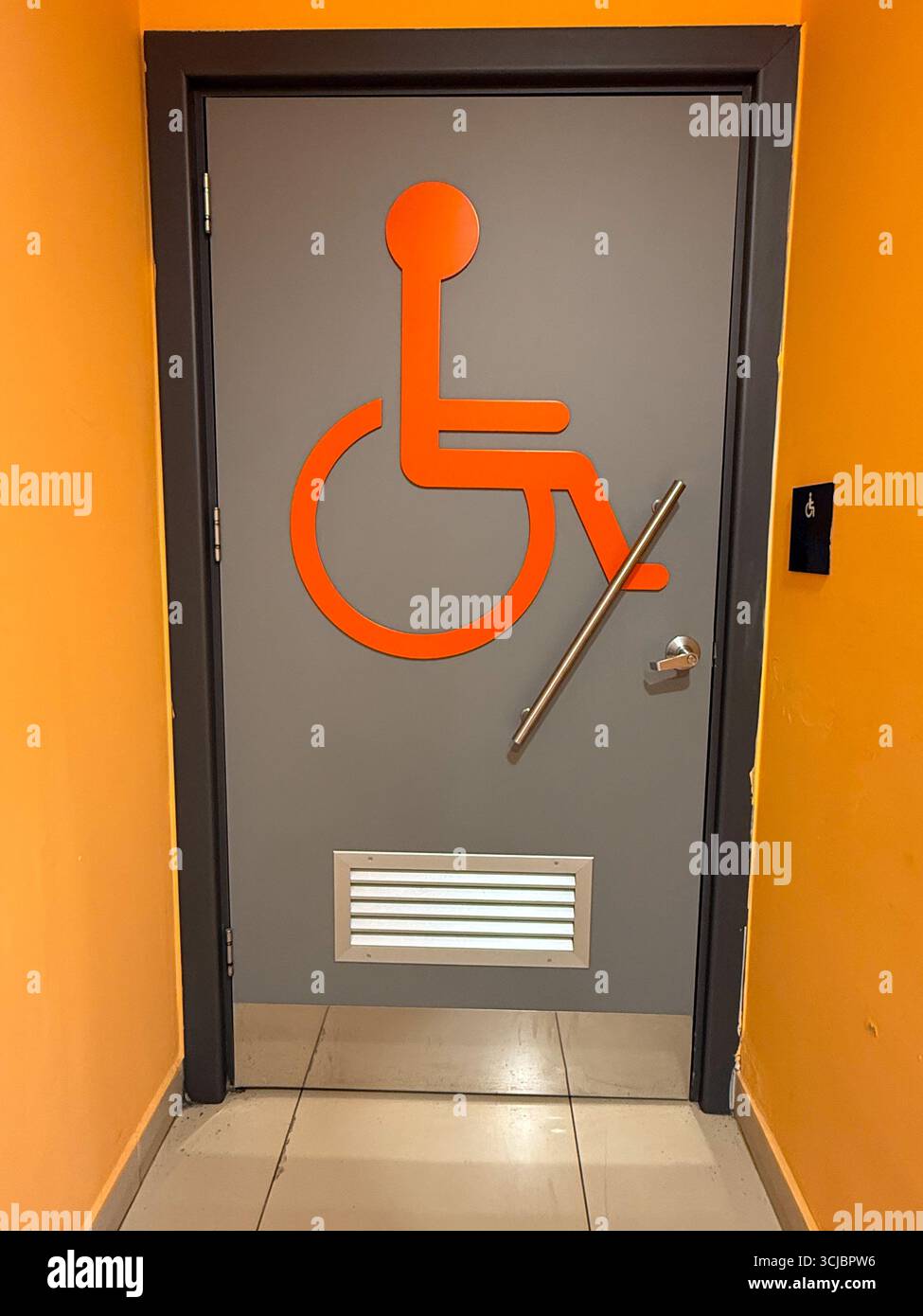 Accessible restroom door with wheelchair symbol. Disability access, inclusion and universal ...