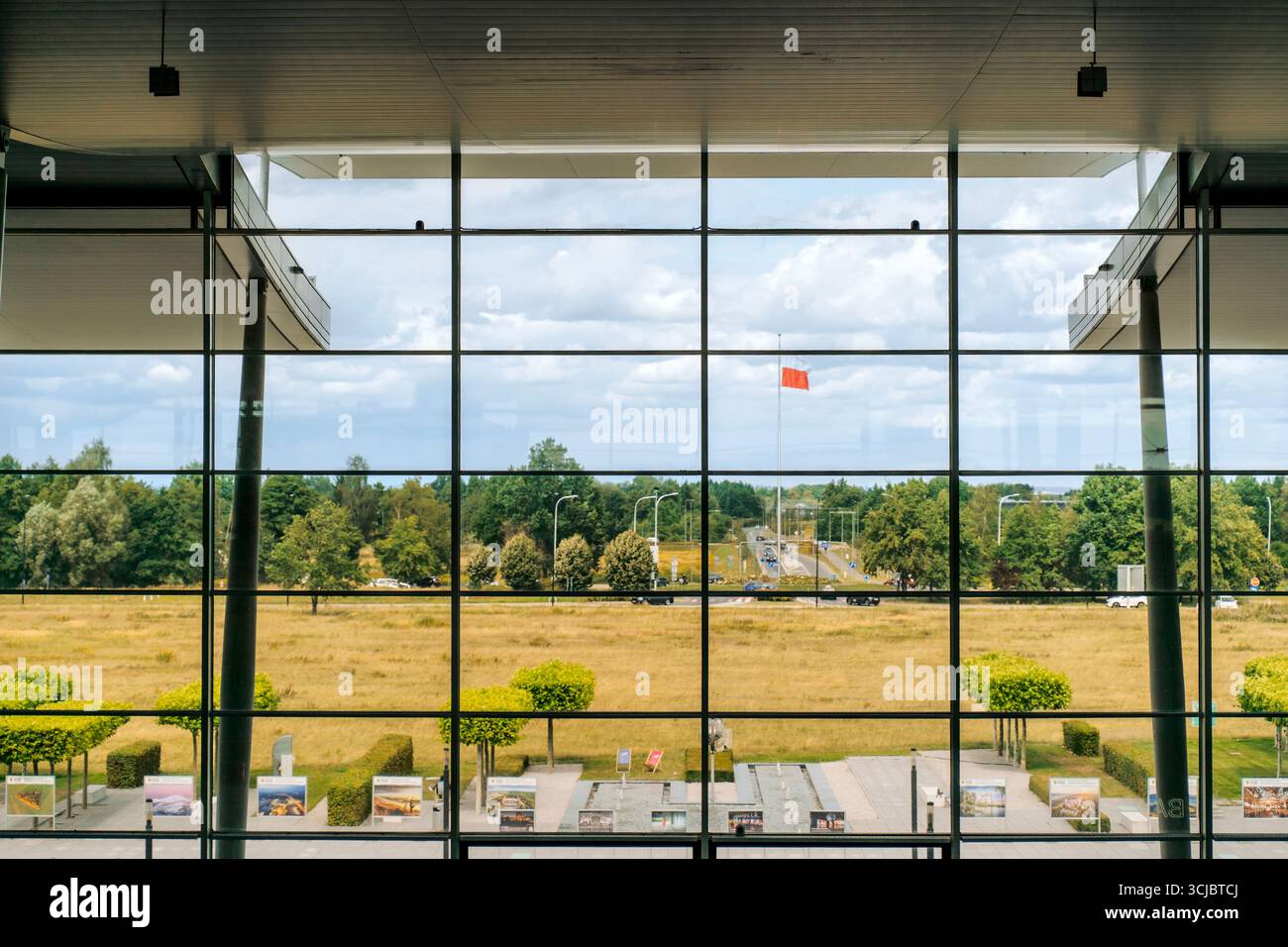 Panoramic airport terminal interior with a large glass window showing ...