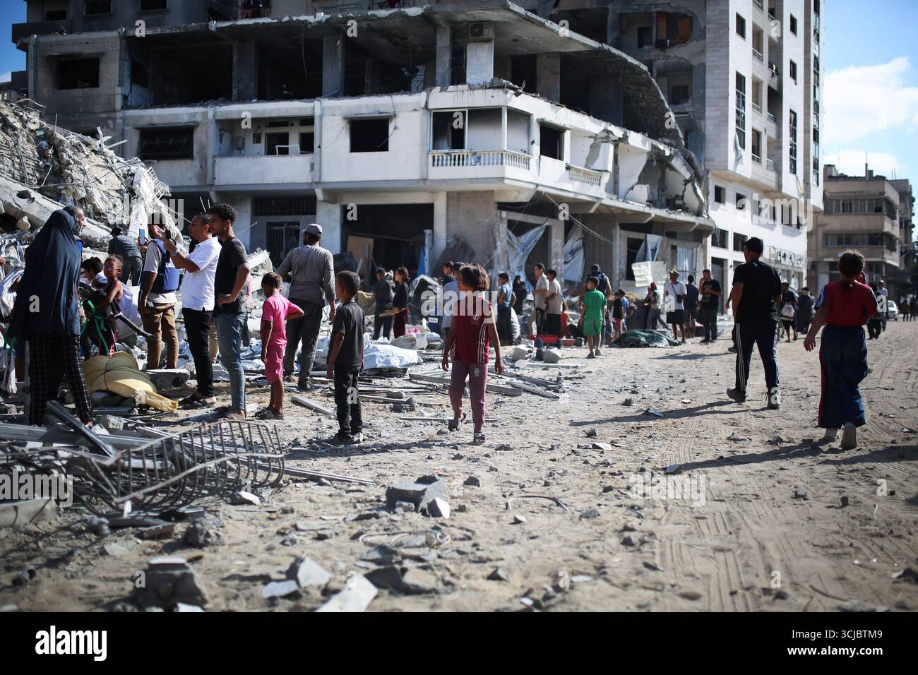 Palestinians check the debris of Al-Susi Tower in Gaza City following ...