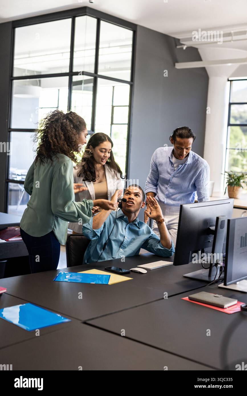 Celebrating success, business team in modern office around computer ...