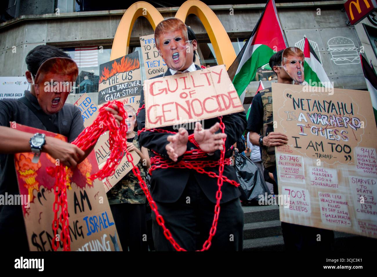 Participants hold placards during a protest against the visit of US ...