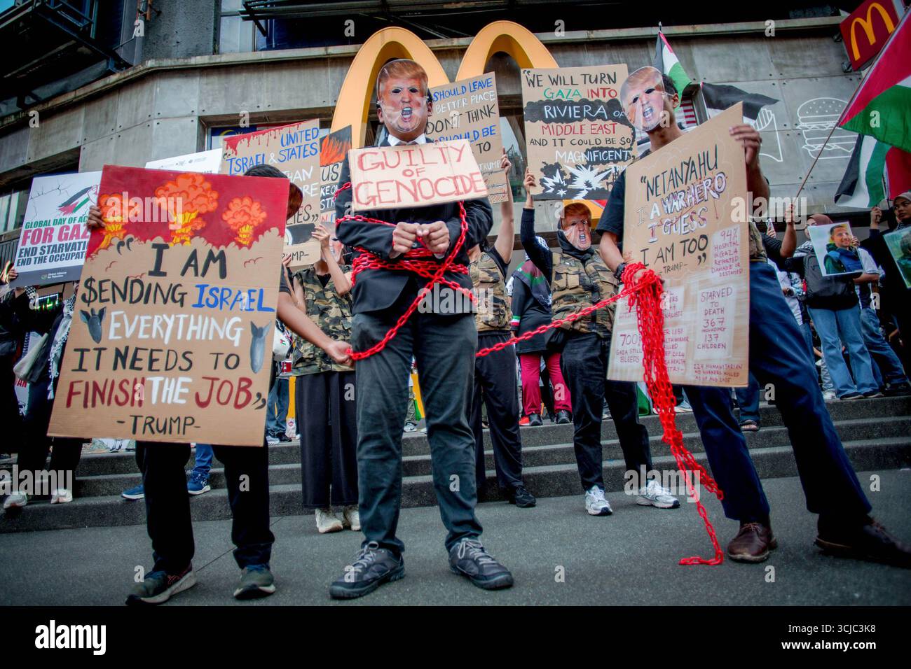 Participants hold placards during a protest against the visit of US ...