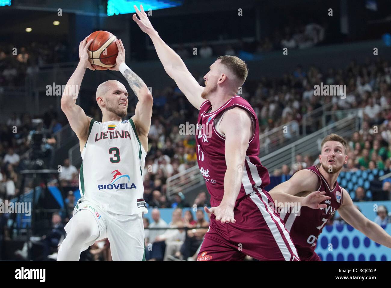 Lithuania's Arnas Velicka, left, tries to shoot while defended by ...