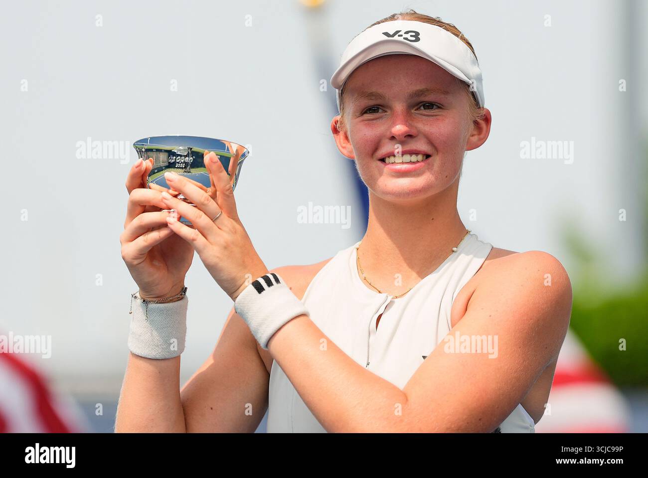 Jeline Vandromme, of Belgium, holds up the championship trophy after ...