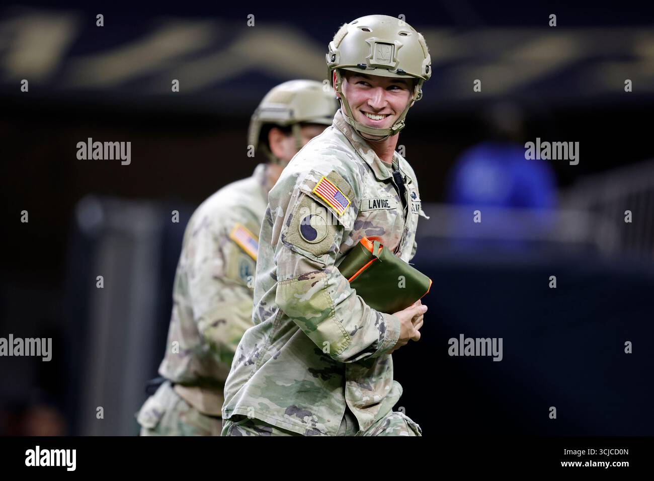 A member of the US Army runs off the field after halftime during an NFL ...