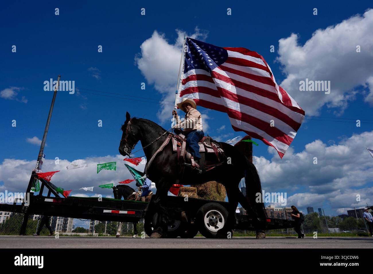 Participants wave flags during the 2025 Pilsen Mexican Independence Day ...