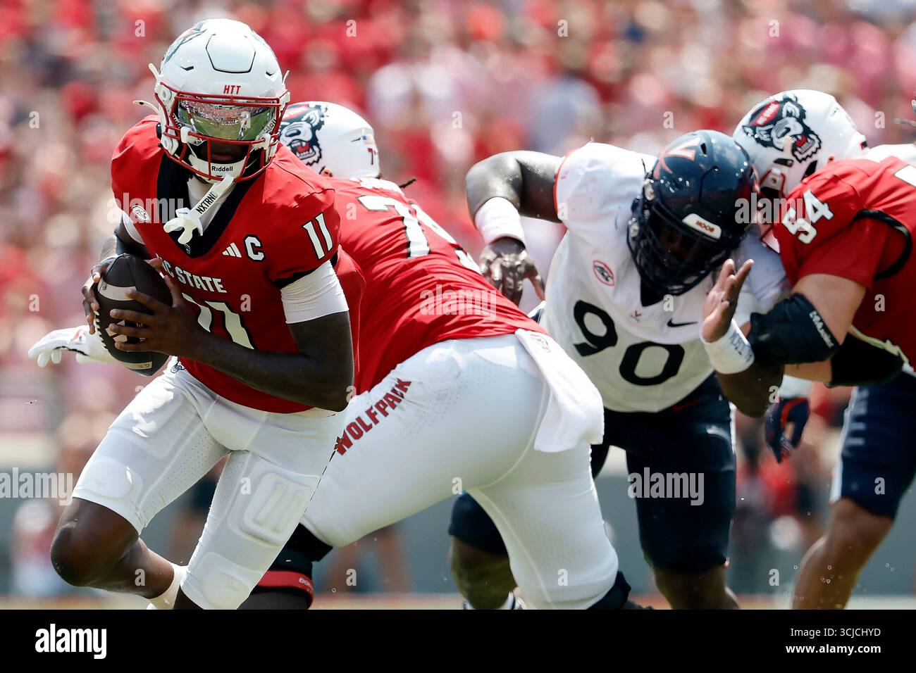 North Carolina State quarterback CJ Bailey (11) turns away from the ...