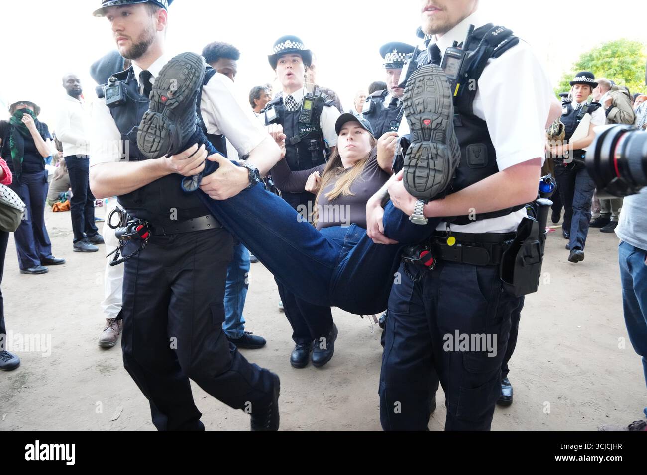 Police officers remove a protester as demonstrators take part in a Lift ...