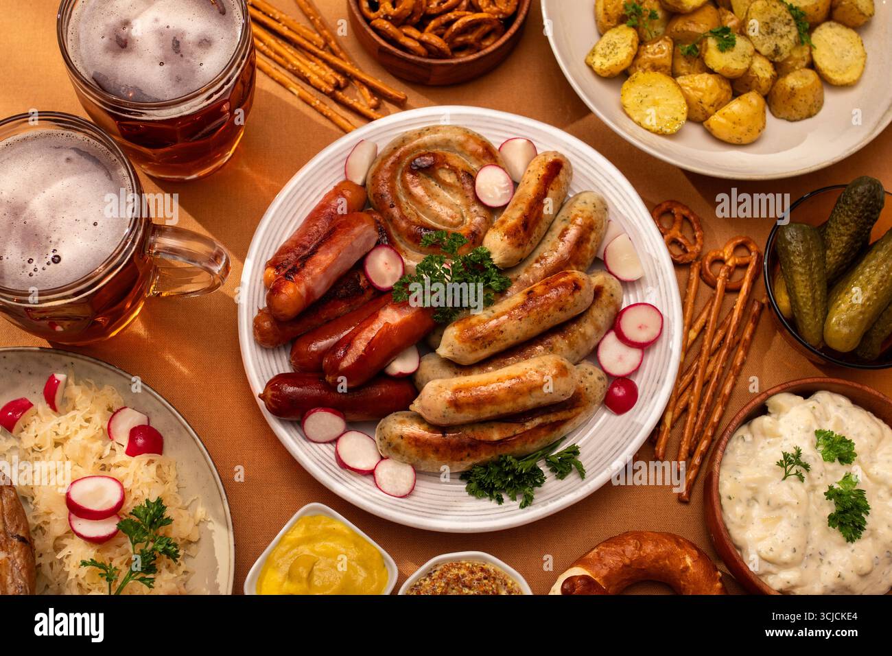 Top view of a German feast featuring assorted sausages, creamy potato ...
