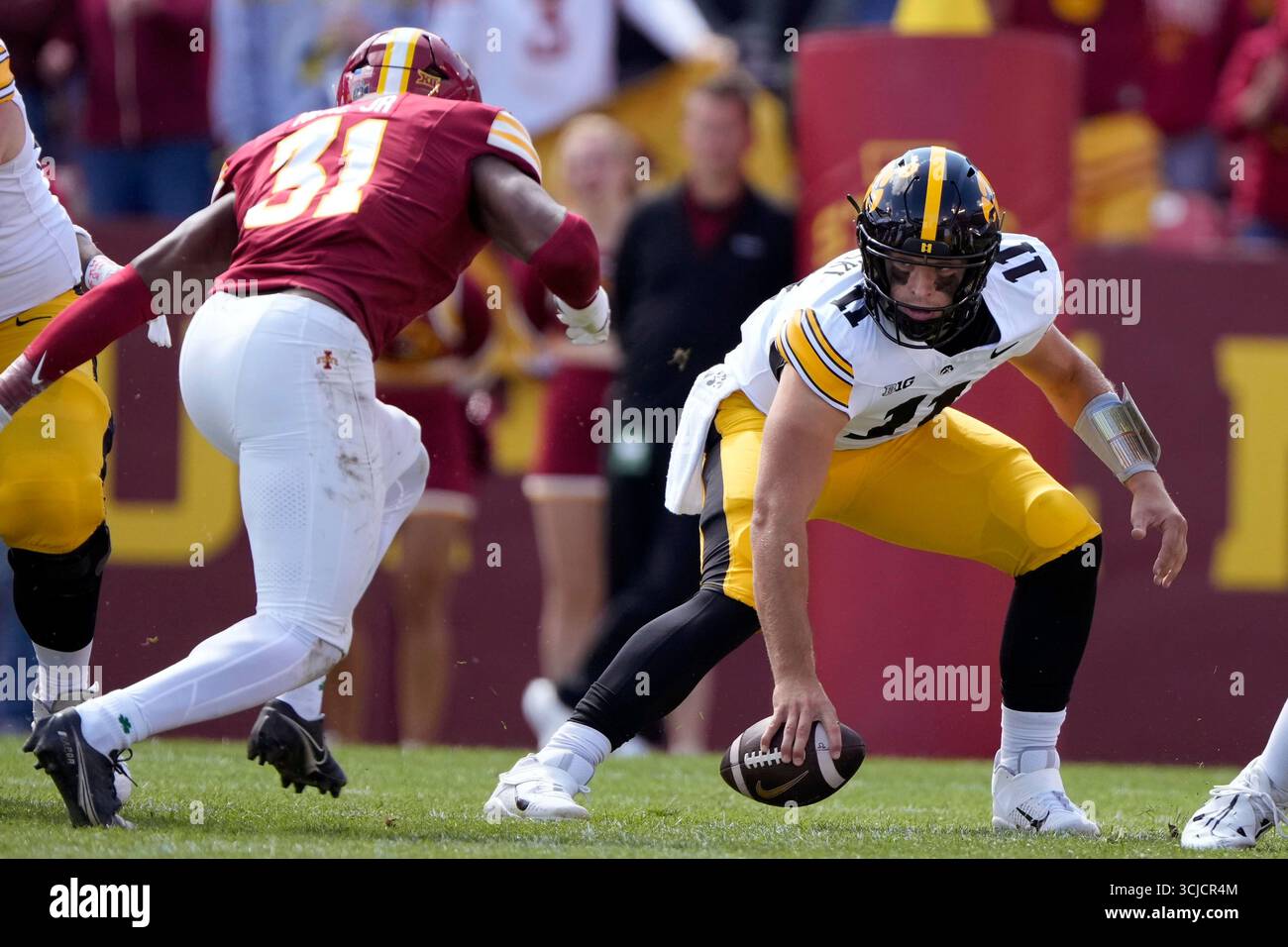 Iowa quarterback Mark Gronowski (11) picks up a fumble in front of Iowa ...
