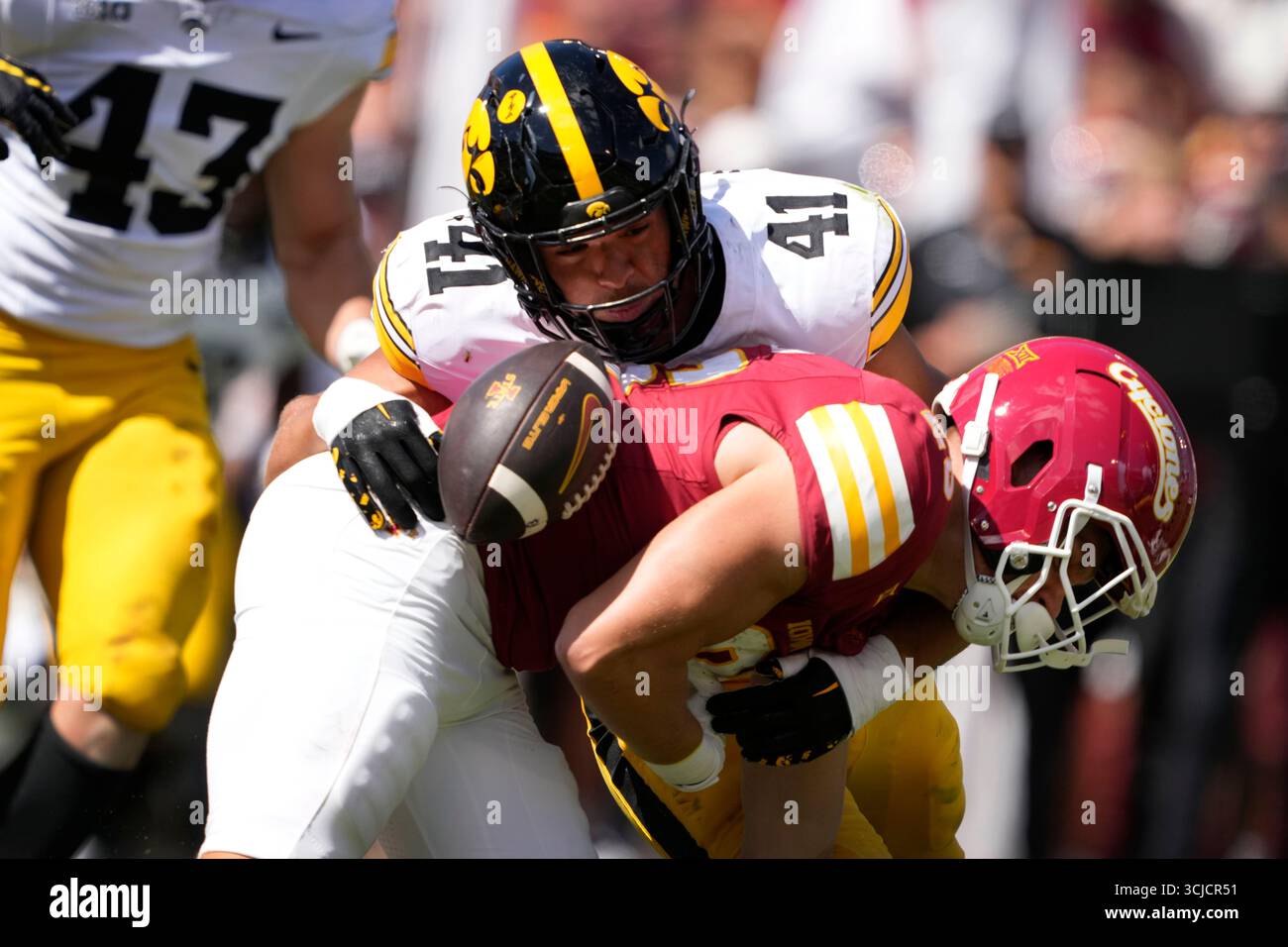 Iowa State running back Carson Hansen fumbles as he is tackled by Iowa ...