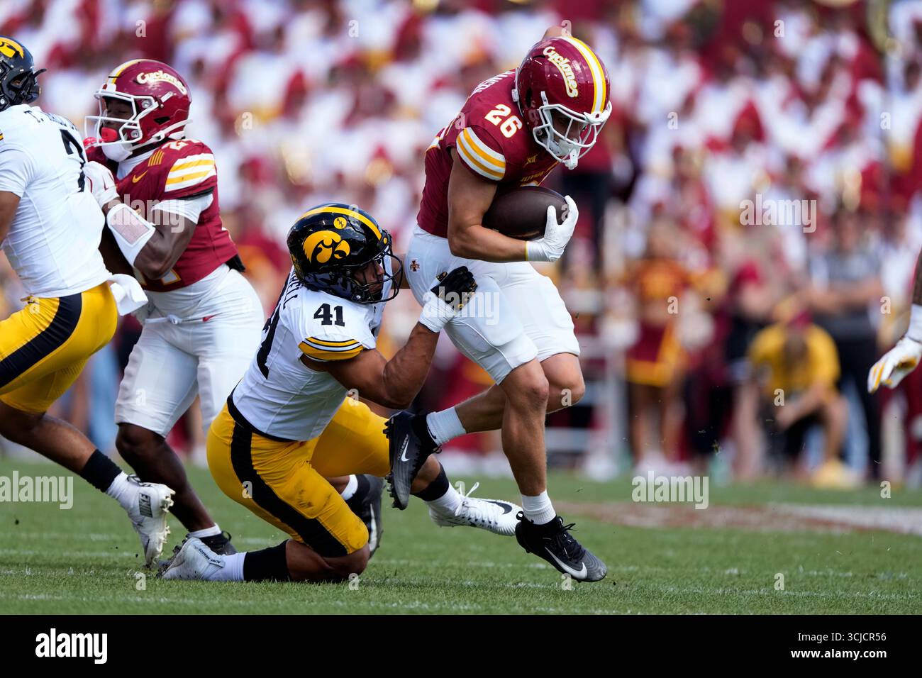 Iowa State running back Carson Hansen (26) tries to break a tackle by ...