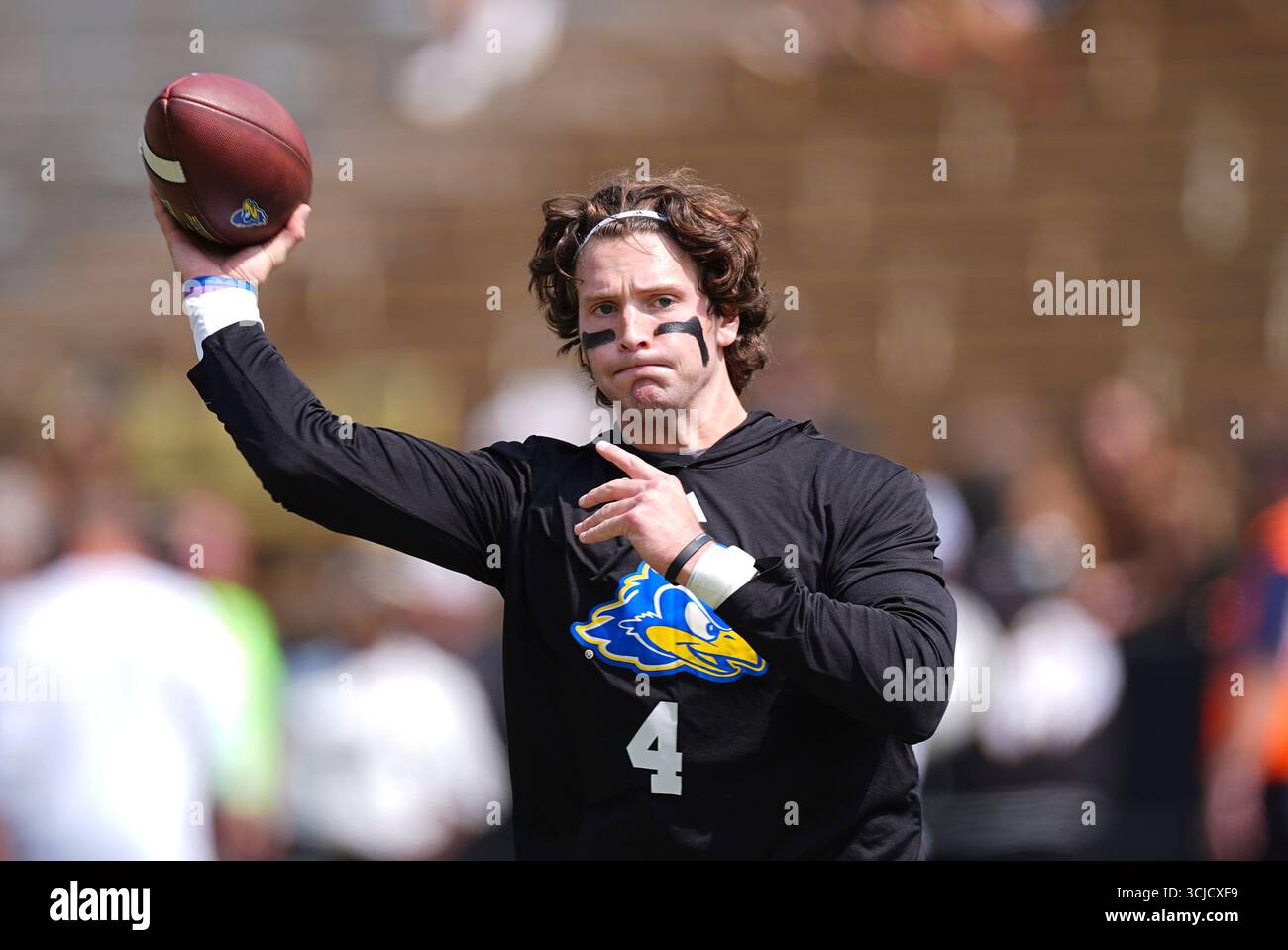 Delaware quarterback Nick Minicucci warms up before an NCAA college ...