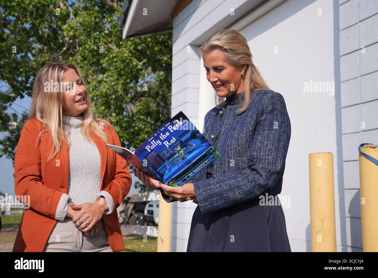 The Duchess of Edinburgh is presented with a book during a visit to the ...